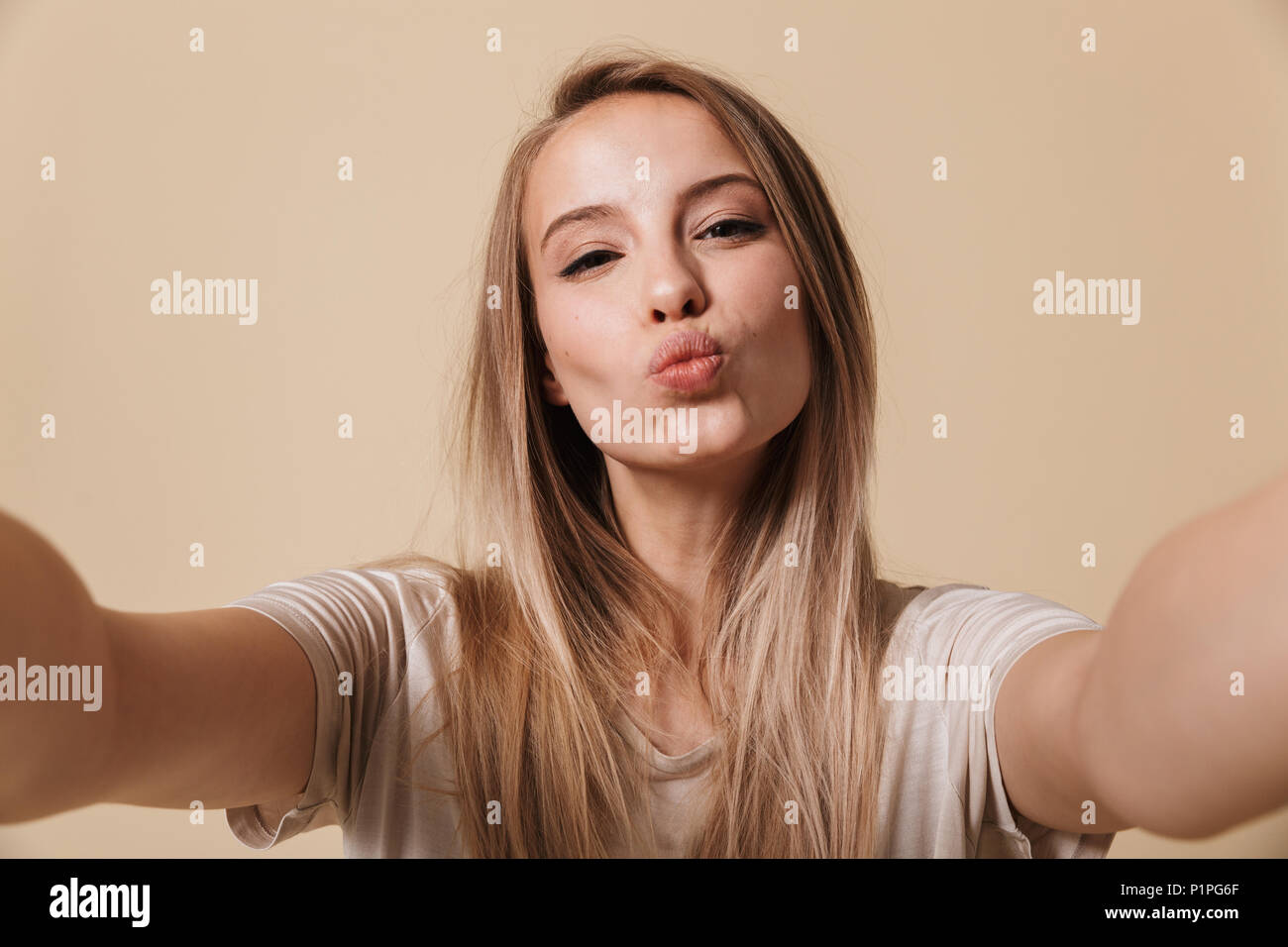 Portrait Of A Pretty Young Girl Taking A Selfie With Outstretched Hands