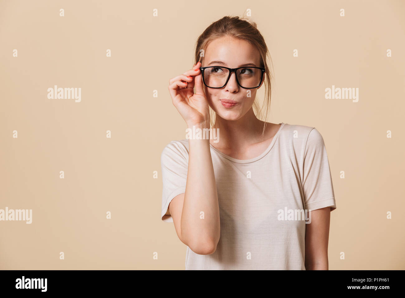 Picture of charming blond woman 20s wearing basic t-shirt touching ... Picture of charming blond woman 20s wearing basic t-shirt touching ...