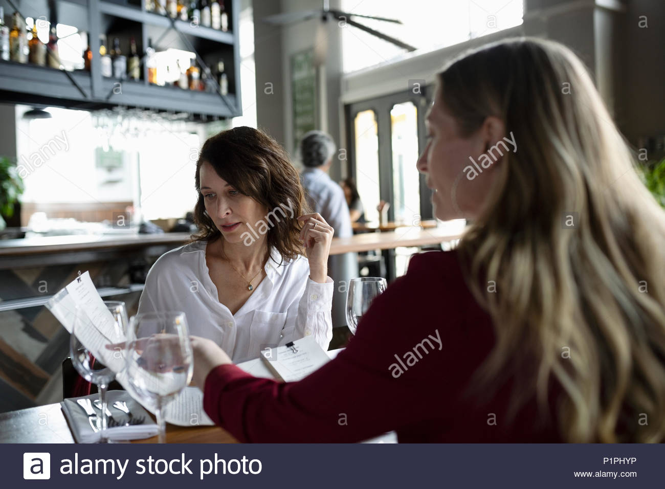 Woman reading menu in restaurant hi-res stock photography and images ...