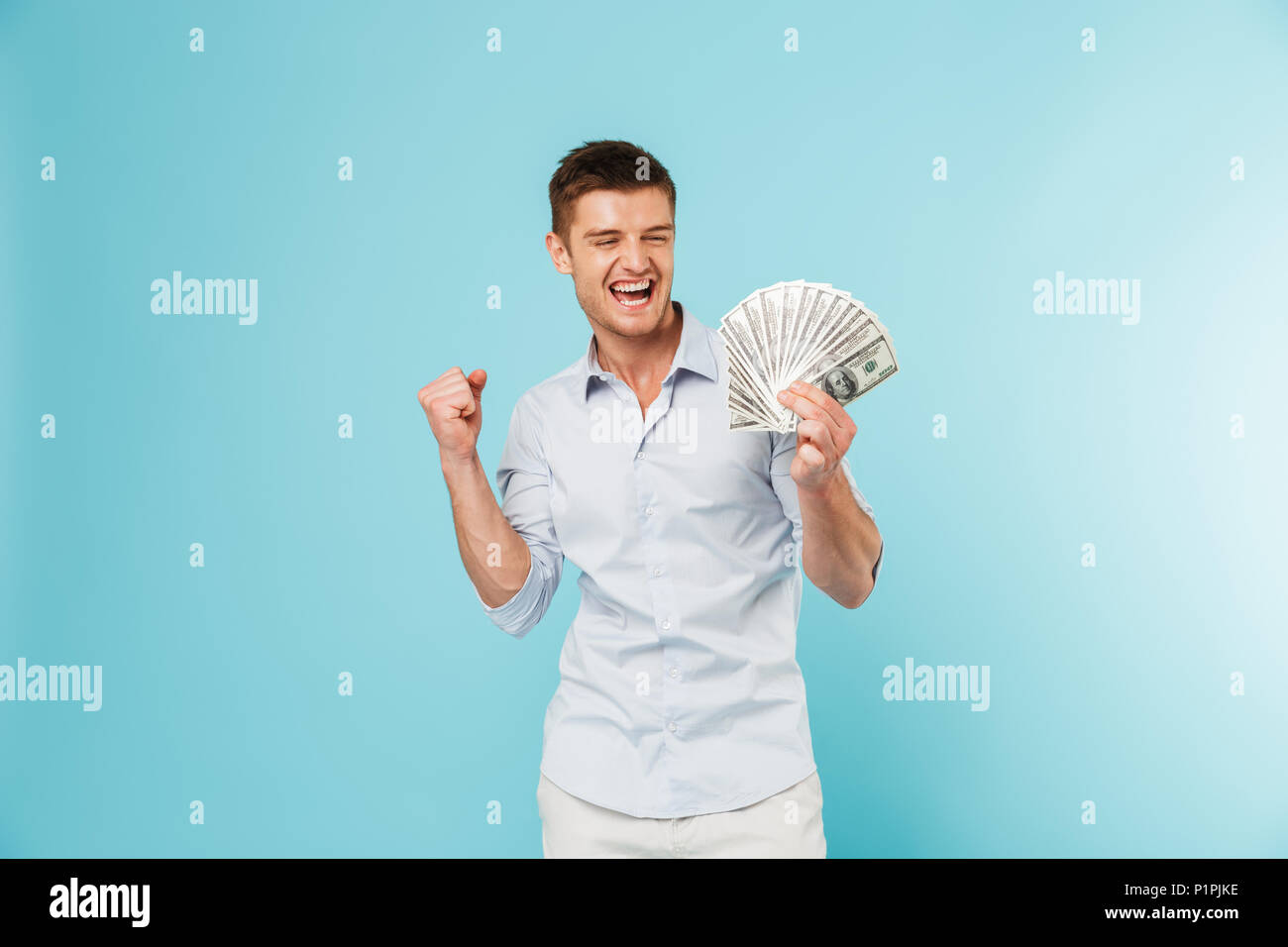 Image of young excited screaming caucasian man isolated over blue ...