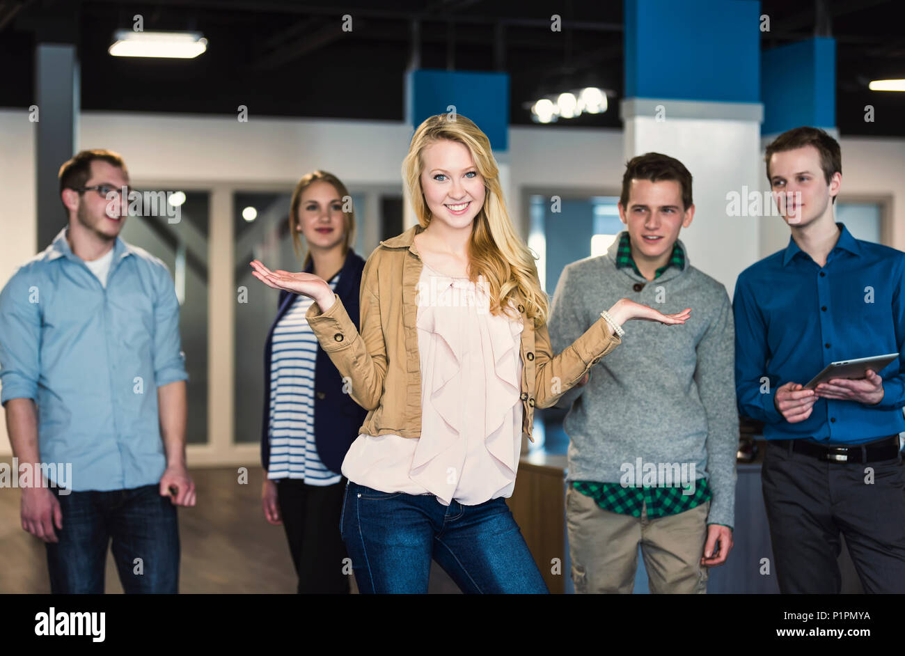Portrait of a group of young millennial professionals standing together ...