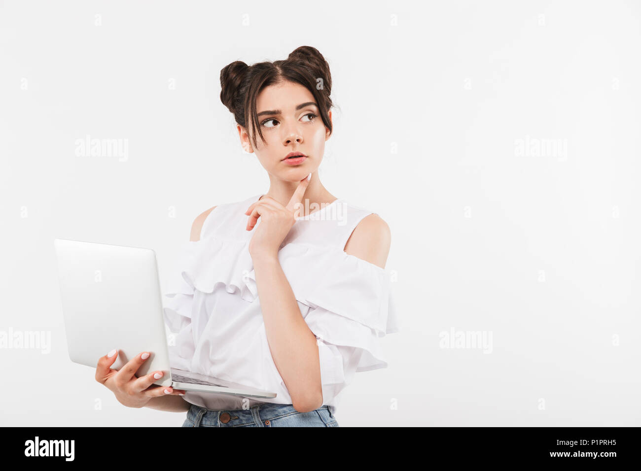 Photo of brooding teenage woman with double buns hairstyle touching ...