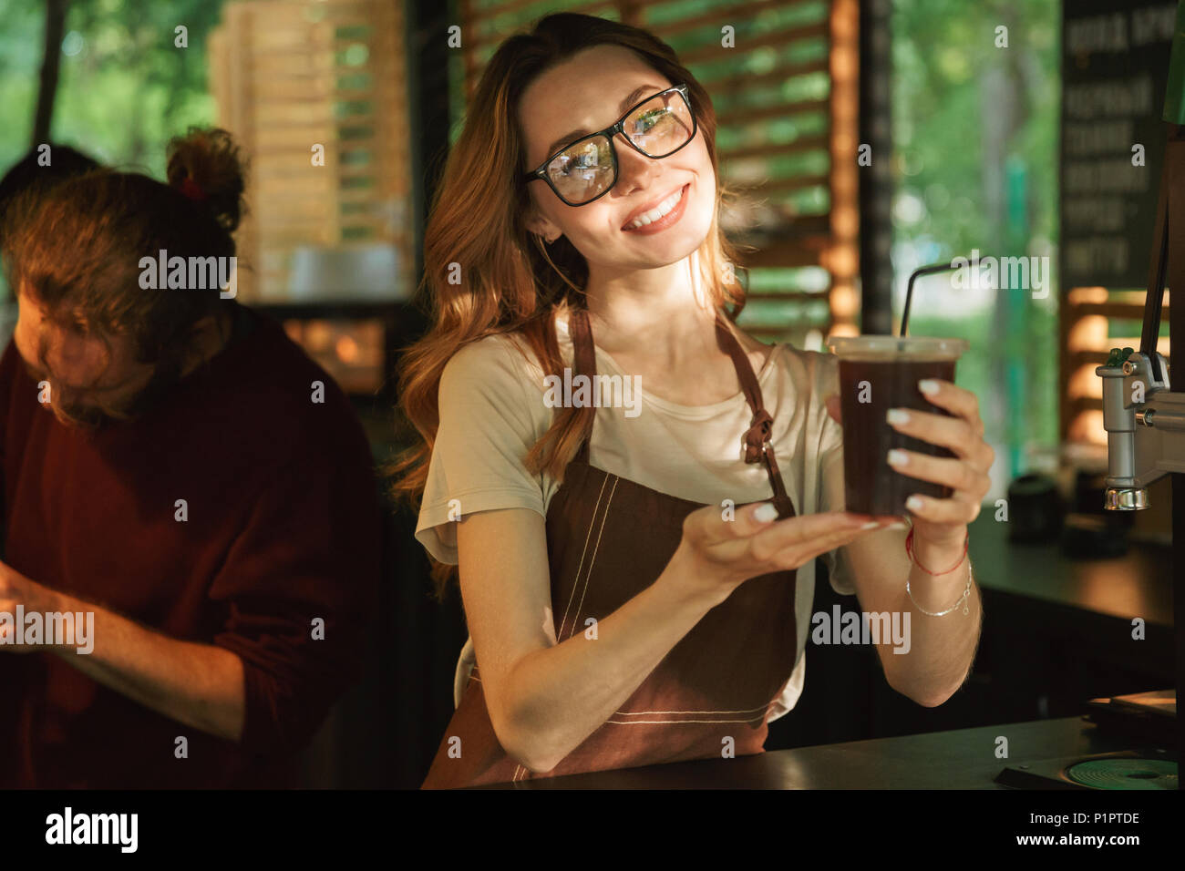 Girl standing behind table hi-res stock photography and images - Alamy