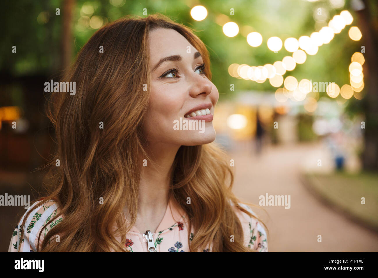 Close up of a pretty young girl looking away outdoors Stock Photo - Alamy