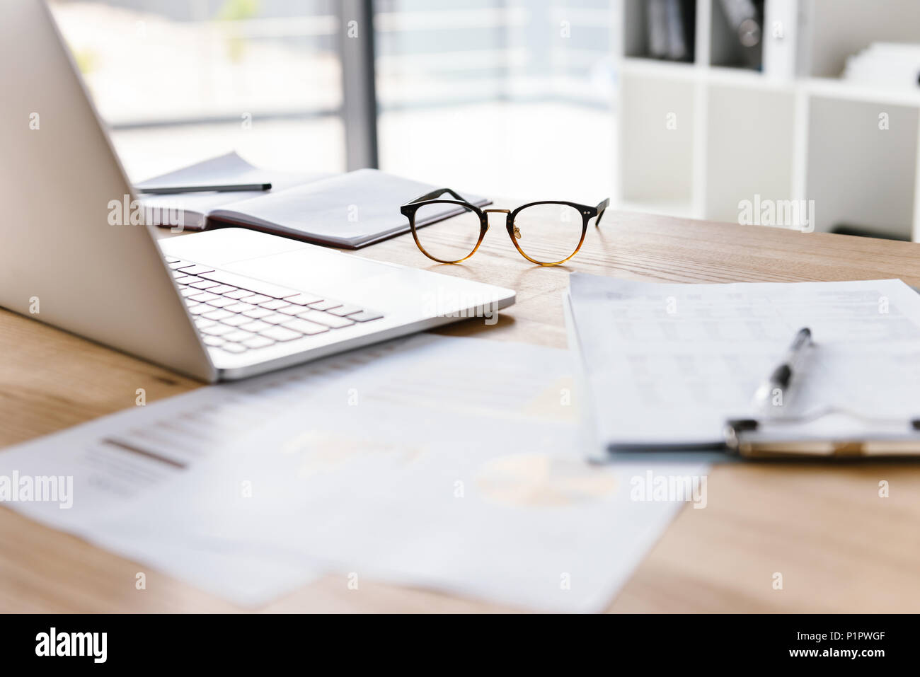 Image of workplace in office room without people with open laptop ...