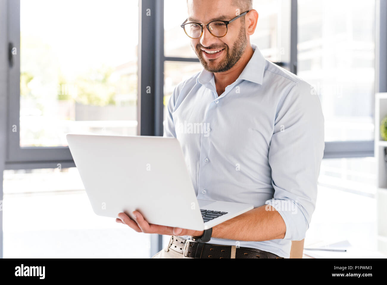 Handsome office man wearing white shirt expressing success, while ...