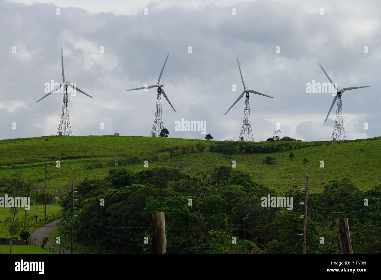 Windmills over cloudy sky in rural area of Costa Rica Stock Photo - Alamy