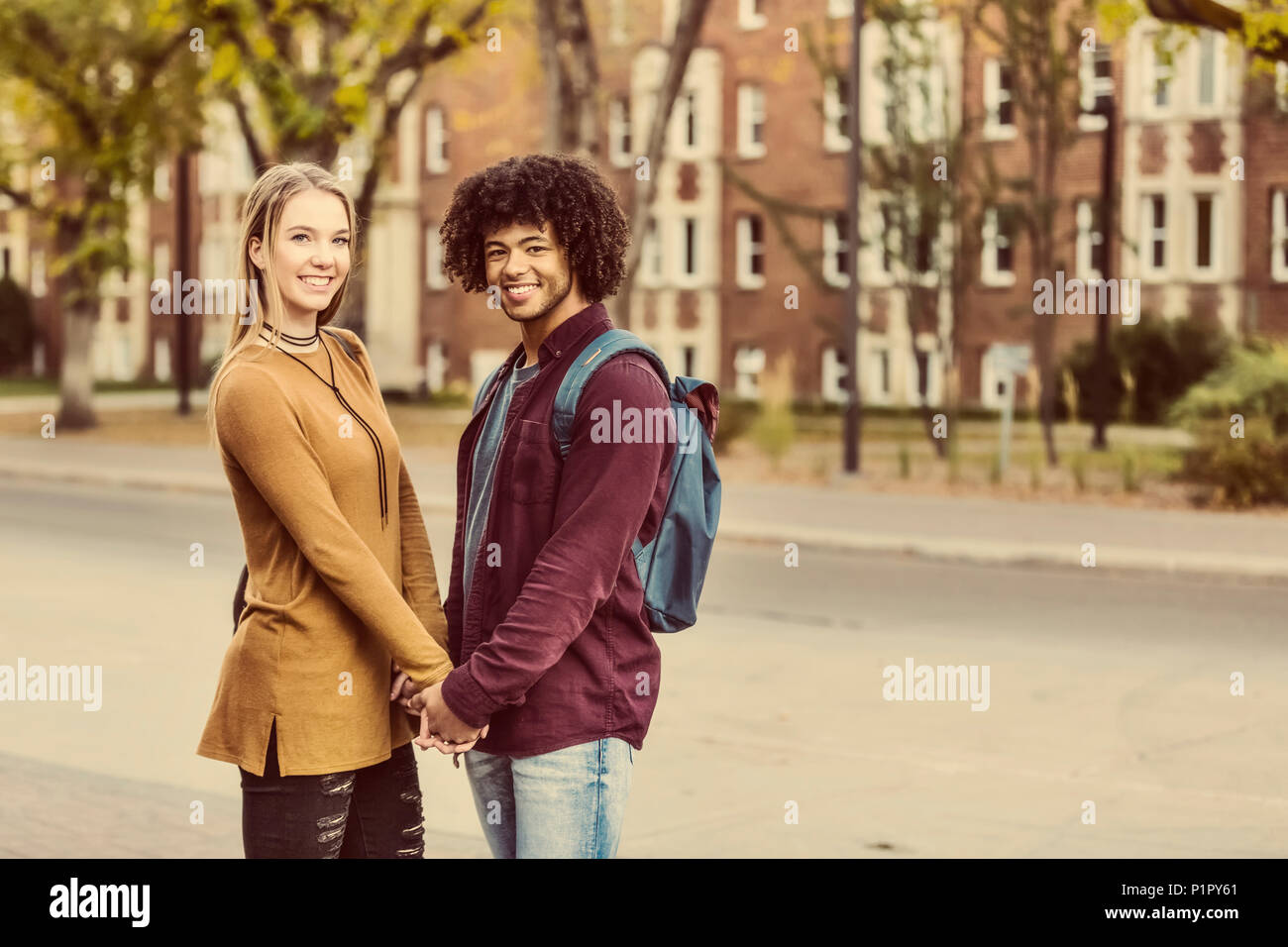 Women standing holding hands hi-res stock photography and images - Alamy