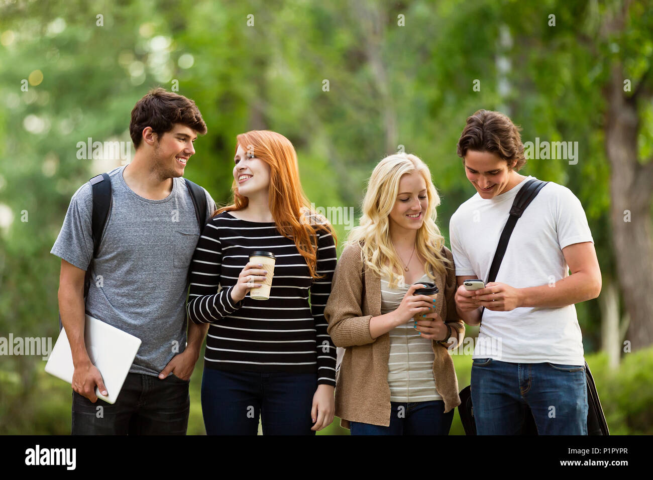 Four friends walking hi-res stock photography and images - Alamy