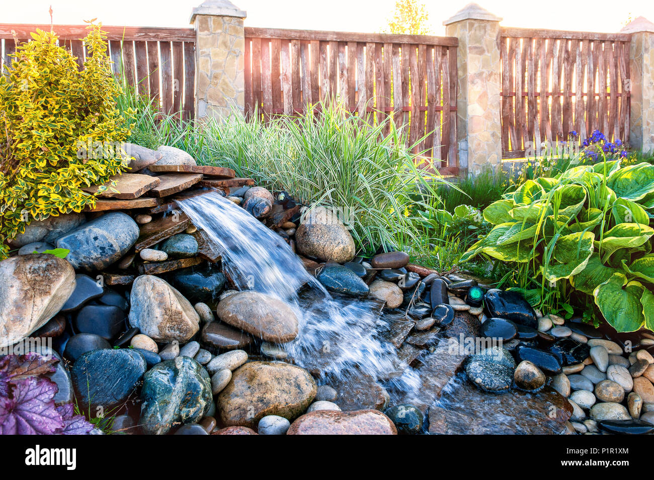 Landscape design, Alpine slide with a large fountain and a stream Stock ...