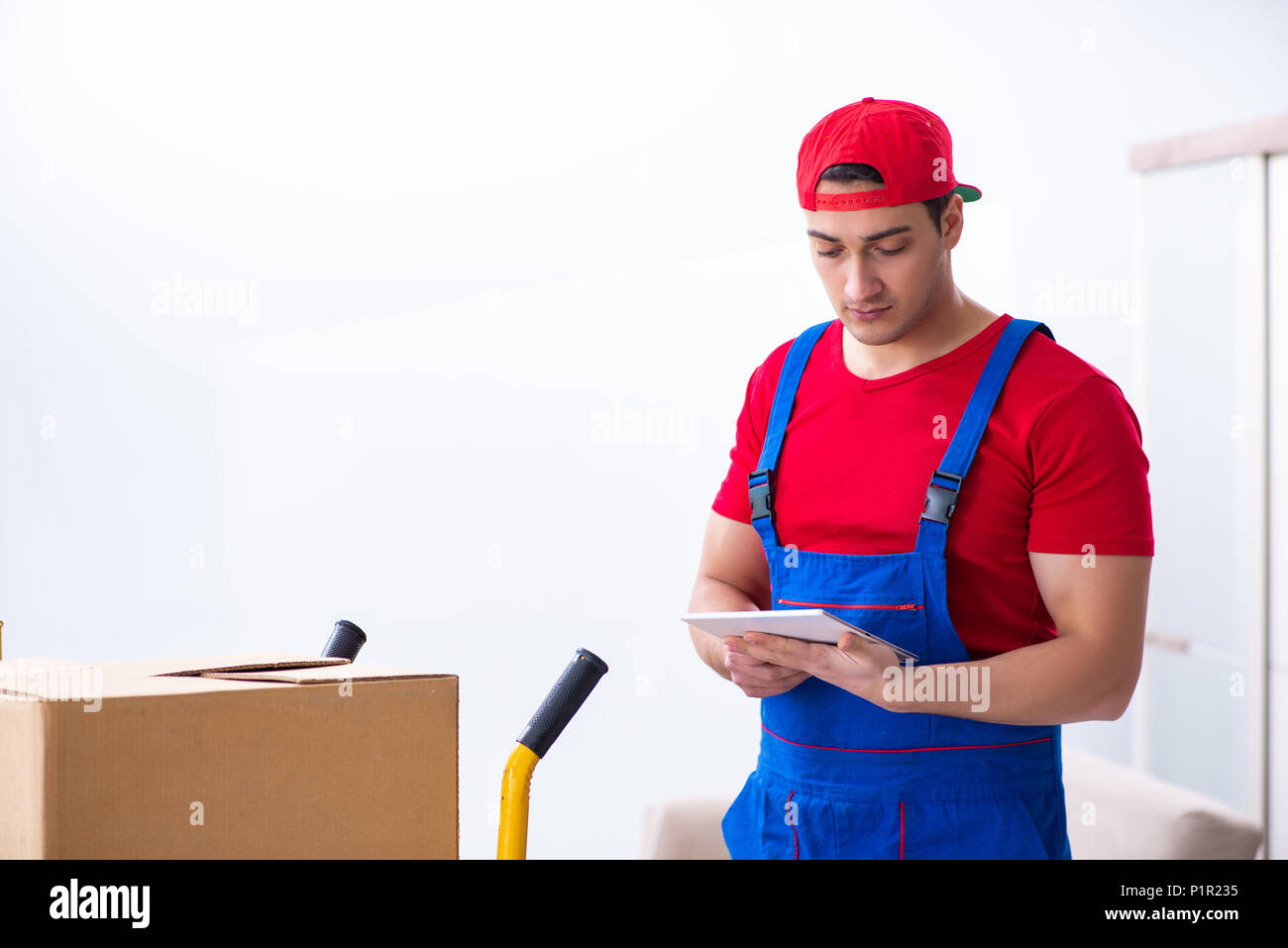 Contractor worker moving boxes during office move Stock Photo - Alamy