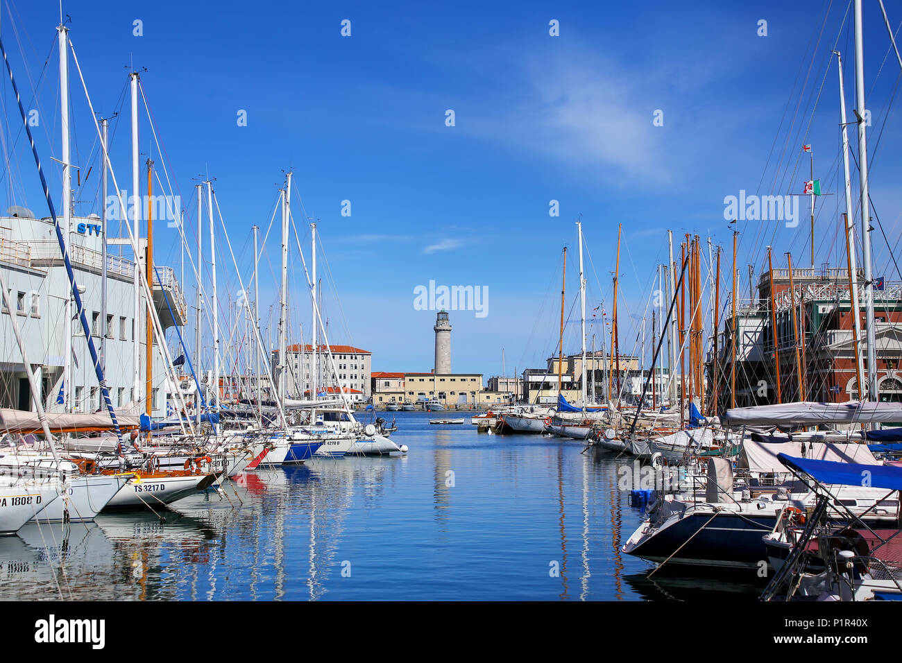 Boat marina and lighthouse in Trieste, Italy. Trieste is the capital of ...