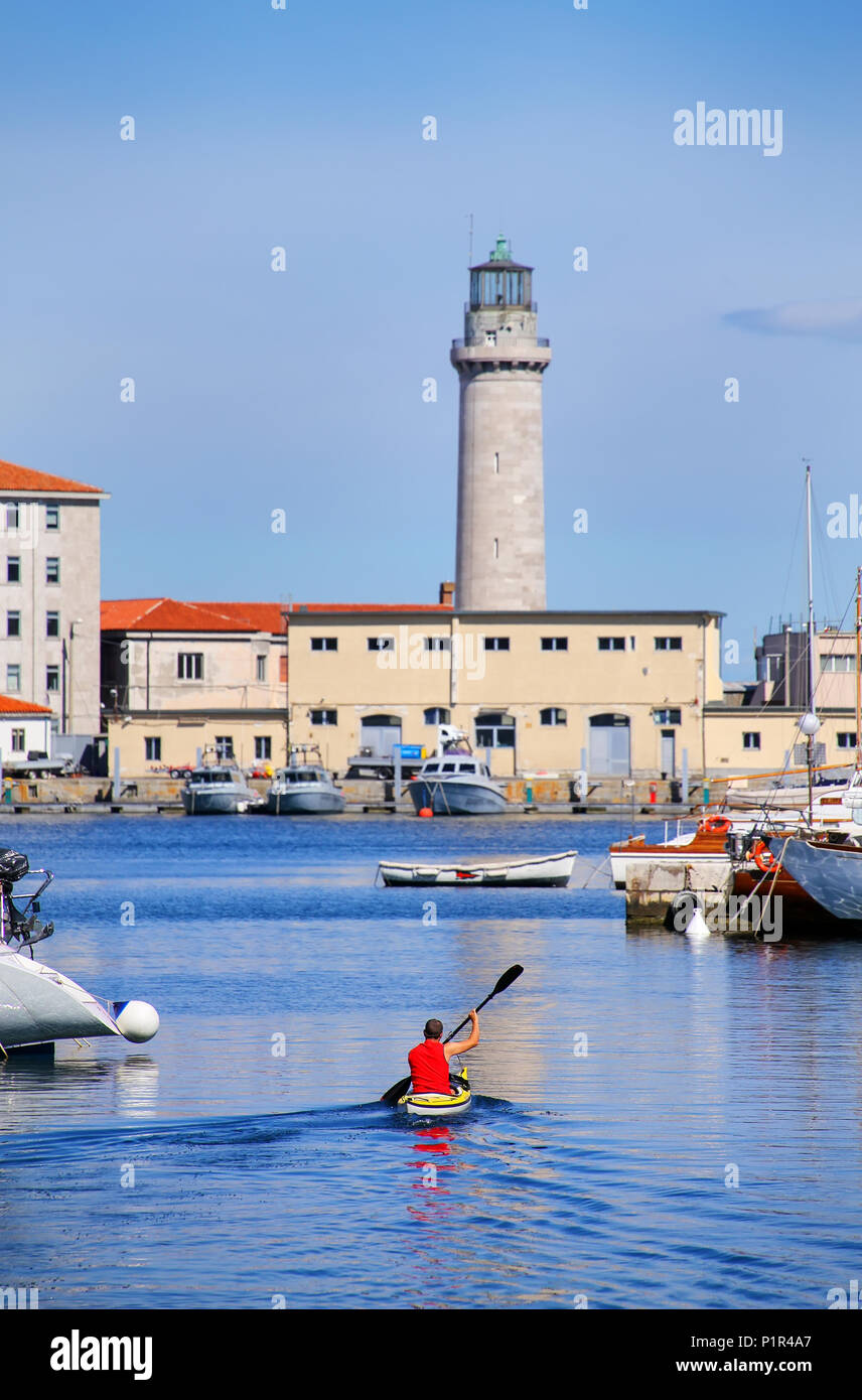 Boat marina and lighthouse in Trieste, Italy. Trieste is the capital of ...