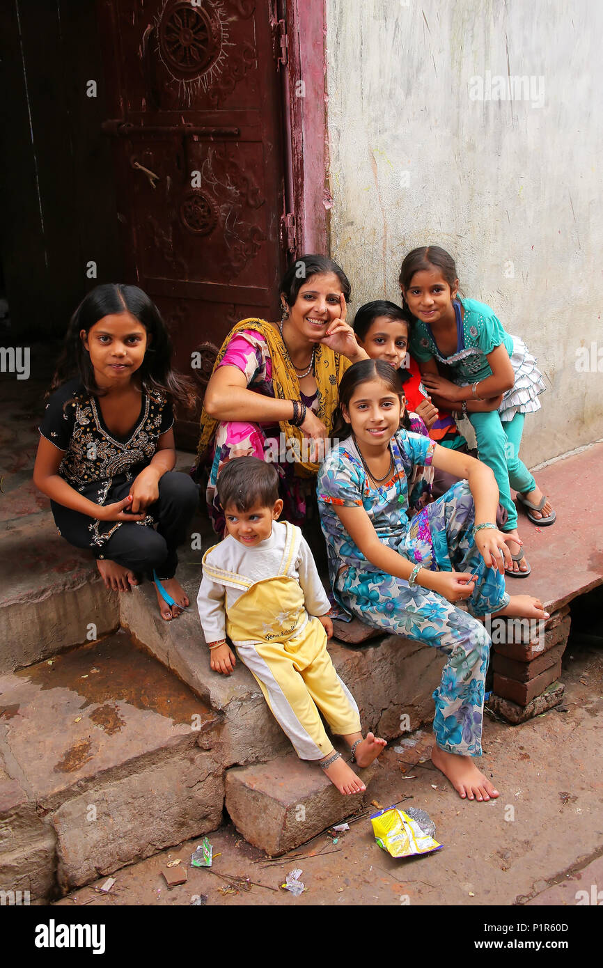 Family sitting on a doorstep in Fatehpur Sikri, Uttar Pradesh, India ...