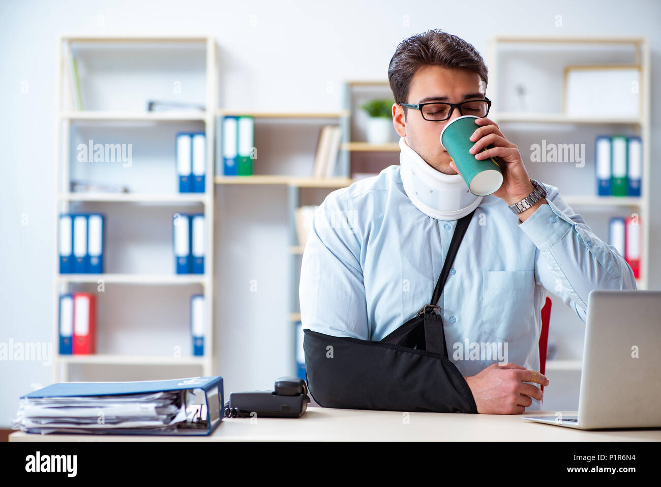 Businessman with broken arm working in office Stock Photo - Alamy