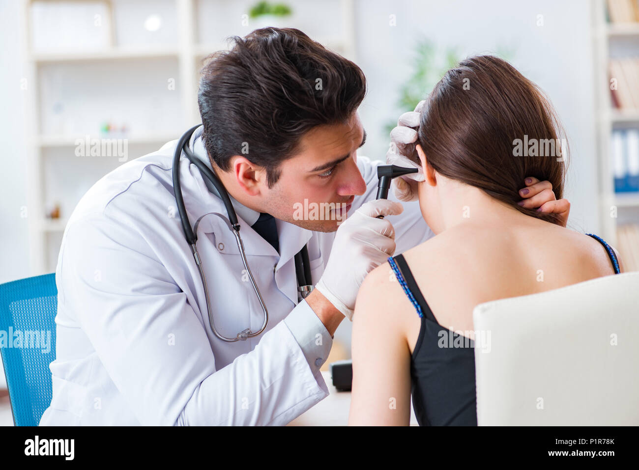 Doctor checking patients ear during medical examination Stock Photo - Alamy