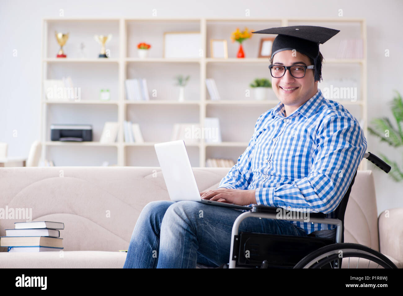 Young student on wheelchair in disability concept Stock Photo - Alamy
