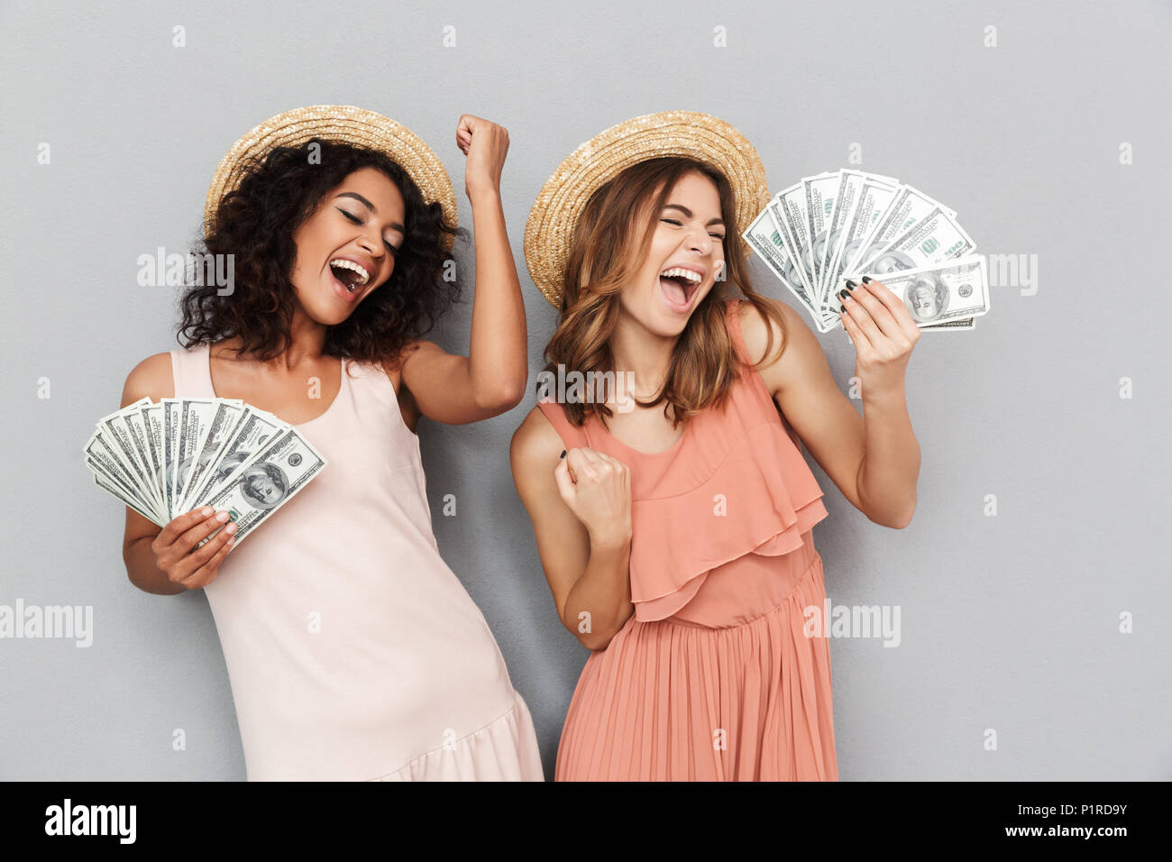 Portrait of two happy delighted girls with different type of skin ...