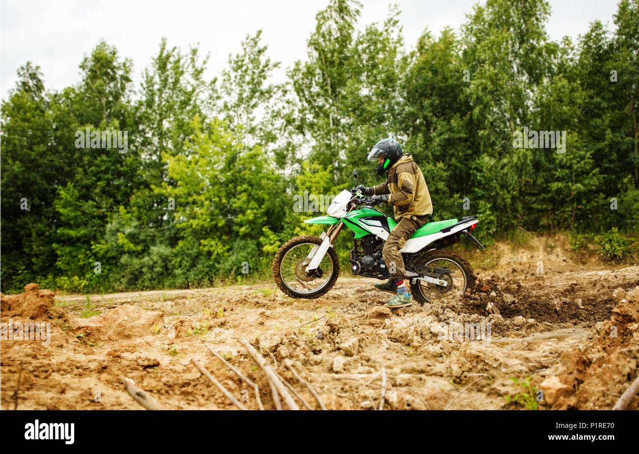 The man on a motorcycle rides through the mud Stock Photo - Alamy