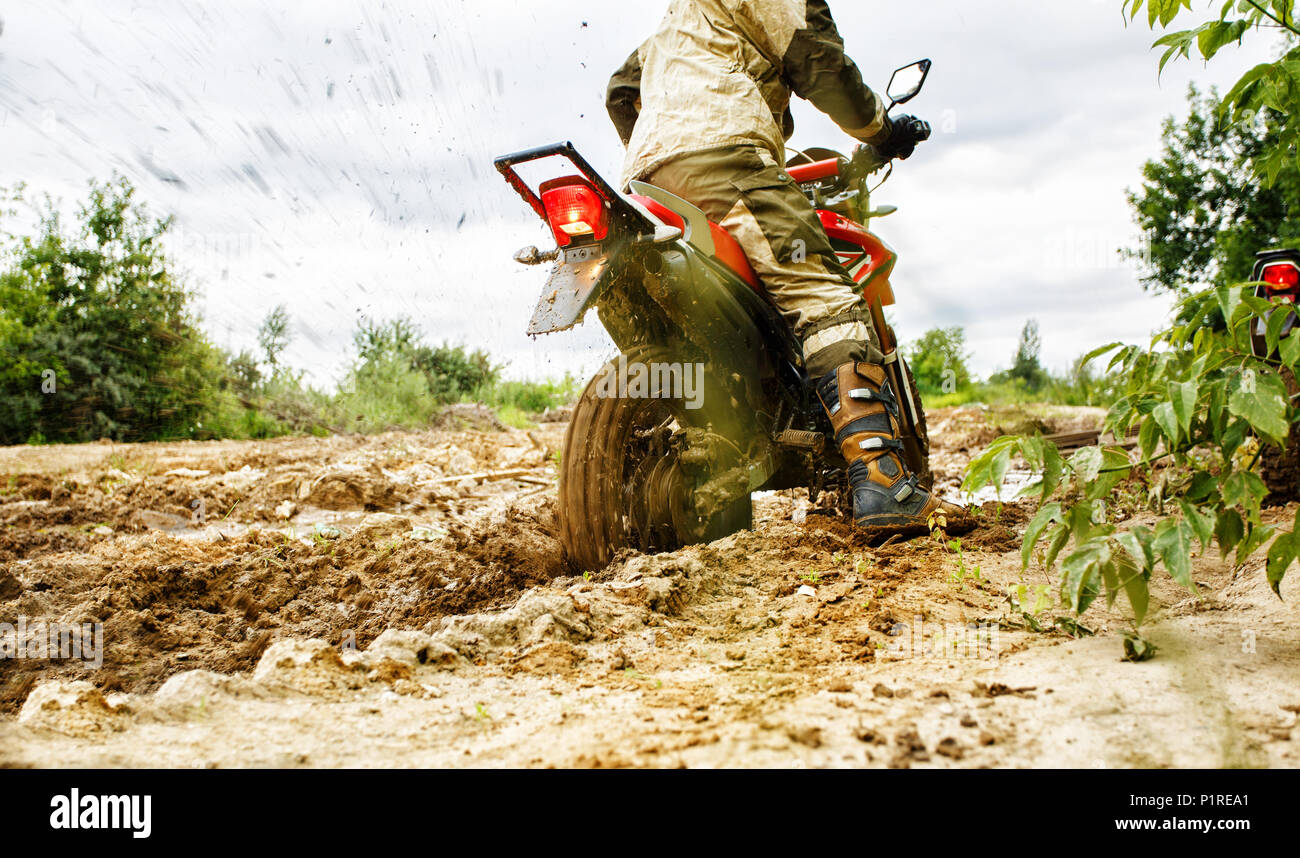 The man on a motorcycle rides through the mud Stock Photo - Alamy