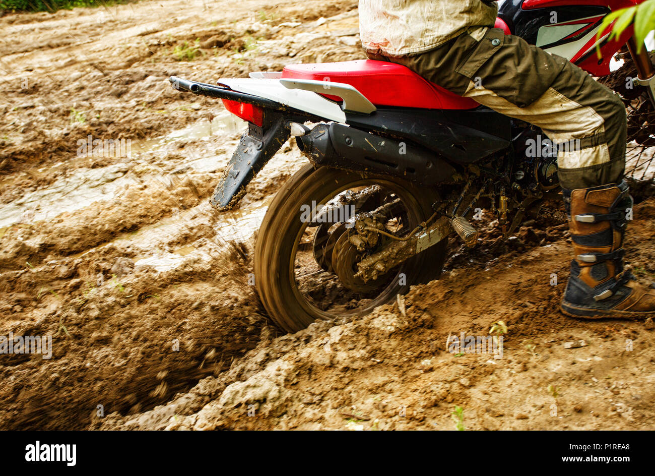 Man rides motorcycle through mud hi-res stock photography and images ...