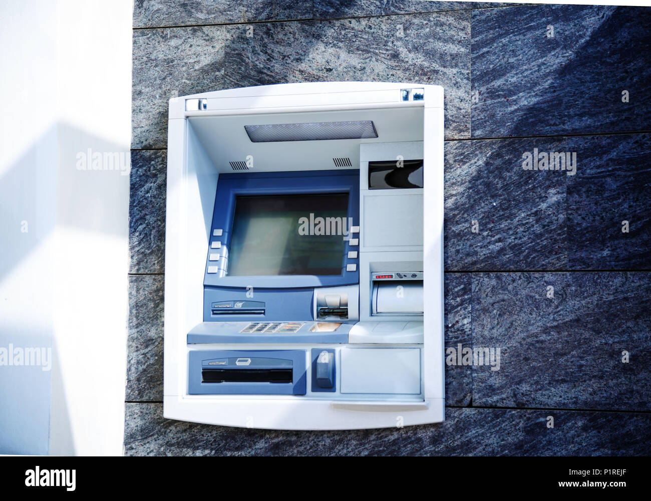ATM in the building wall Stock Photo - Alamy