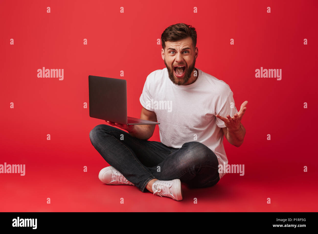 Photo of displeased bored man in t-shirt and jeans screaming and ...
