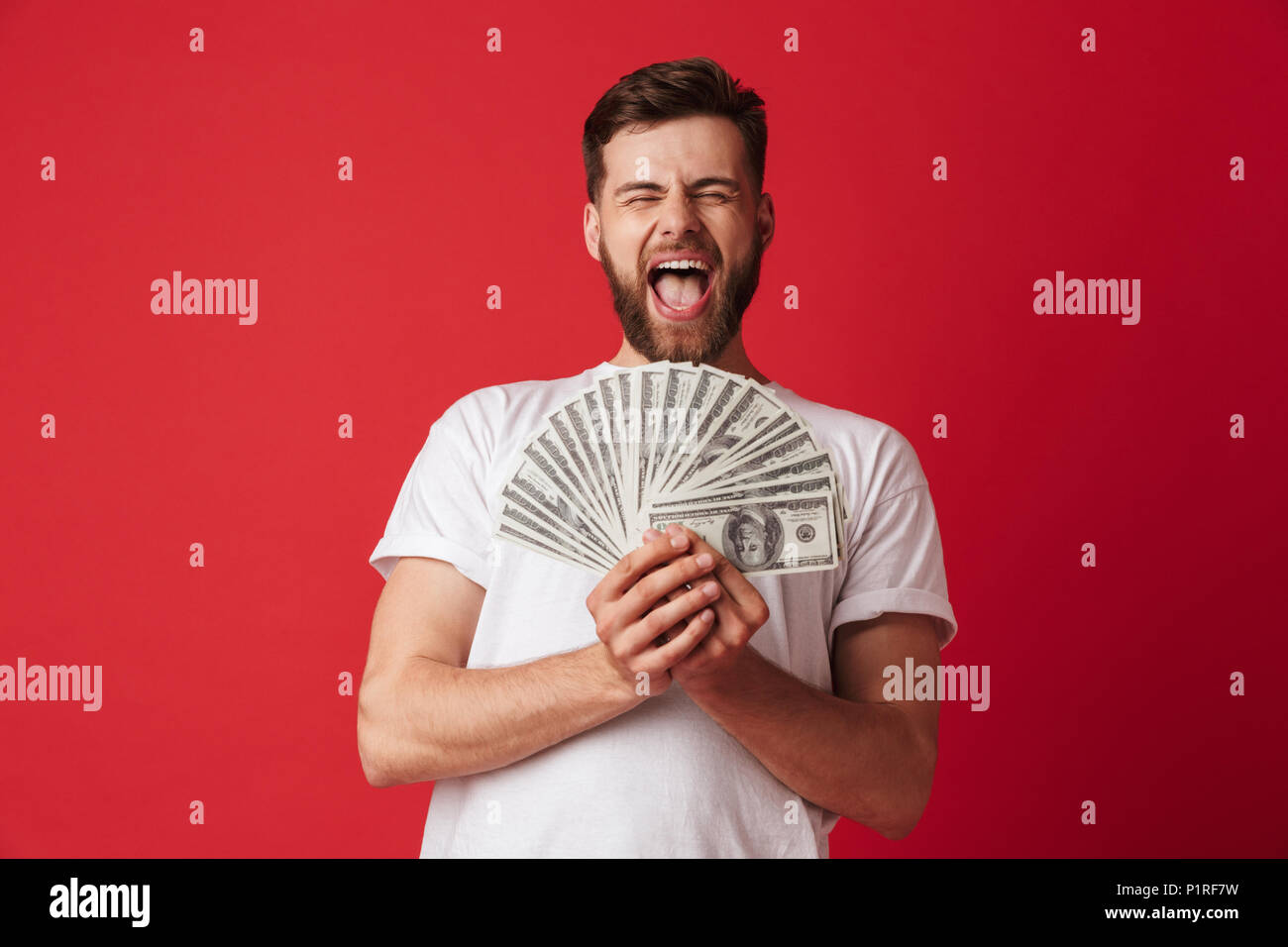Image of excited screaming young man isolated over red wall background ...