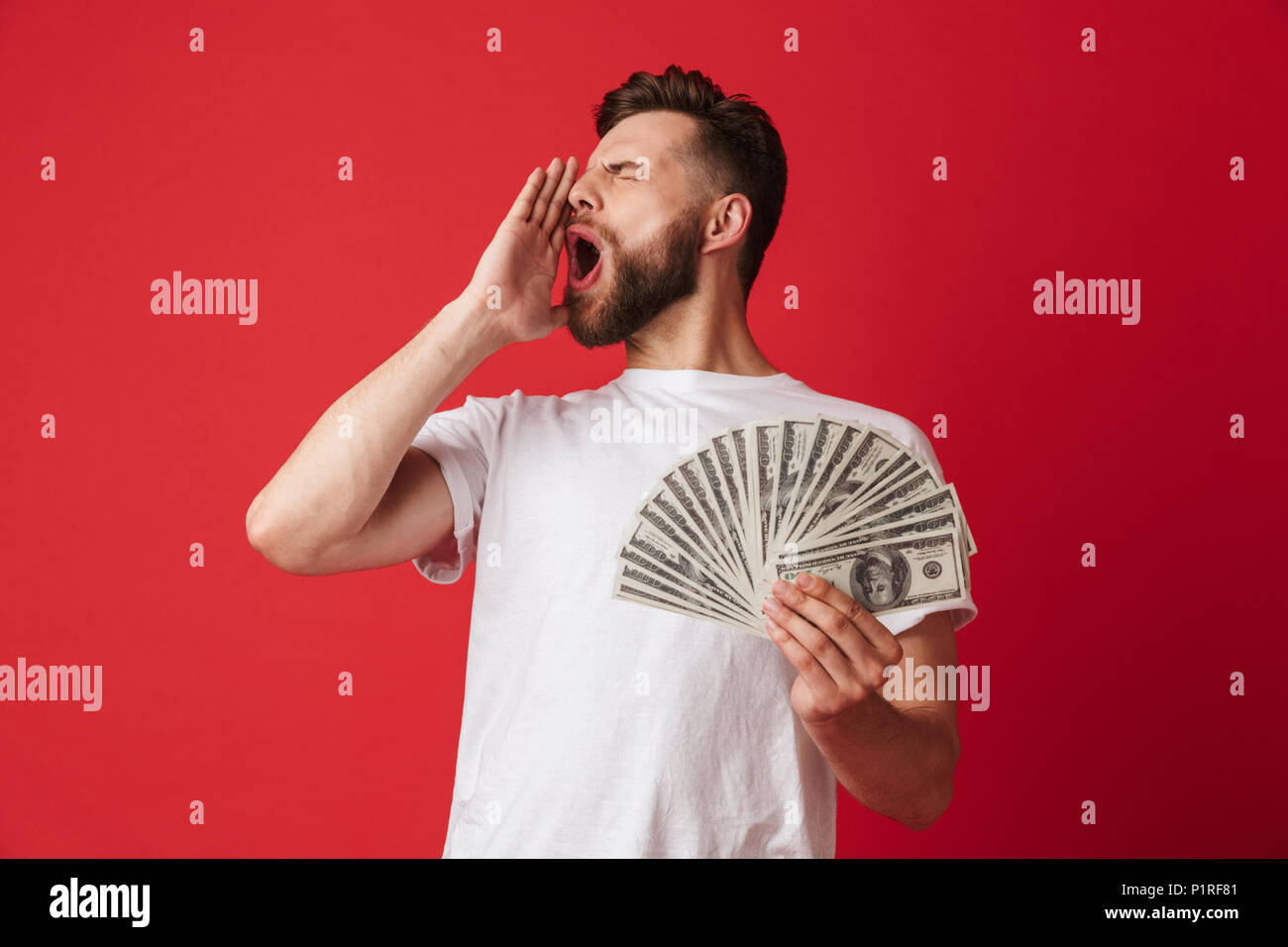 Image of excited screaming young man isolated over red wall background ...