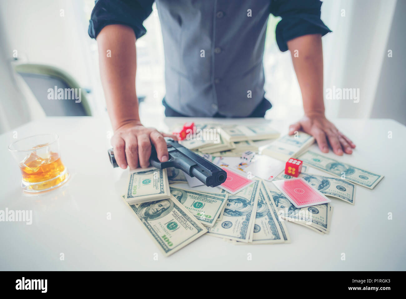 business gangster saying a prayer with his gun Stock Photo - Alamy
