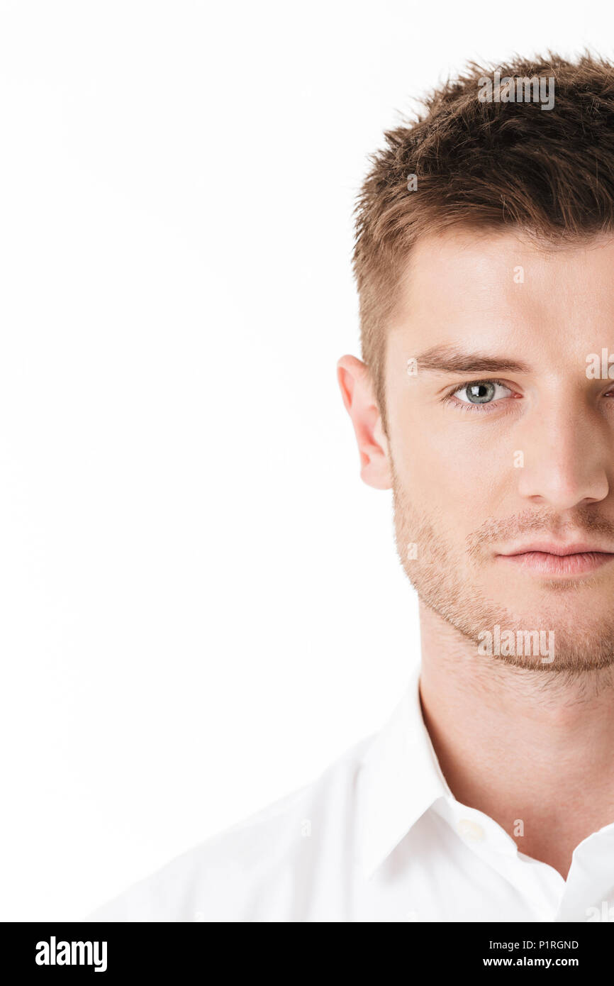 Cropped image of a serious young man's face looking at camera isolated ...