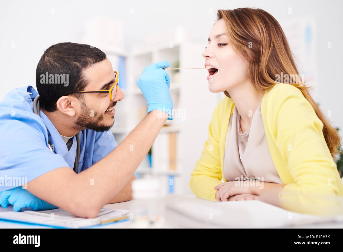 Doctor Examining Young Woman Stock Photo - Alamy