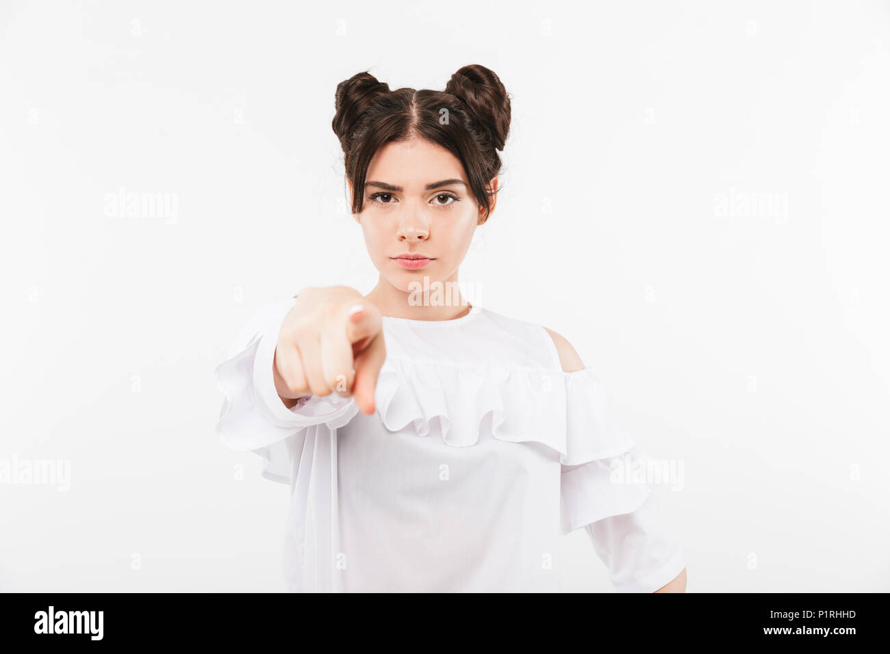Photo of serious strict girl having double buns hairstyle pointing ...