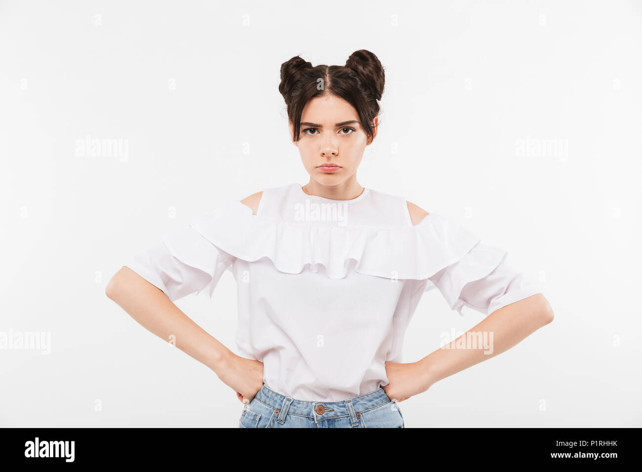 Portrait of resented girl 20s having double buns hairstyle frowning and ...