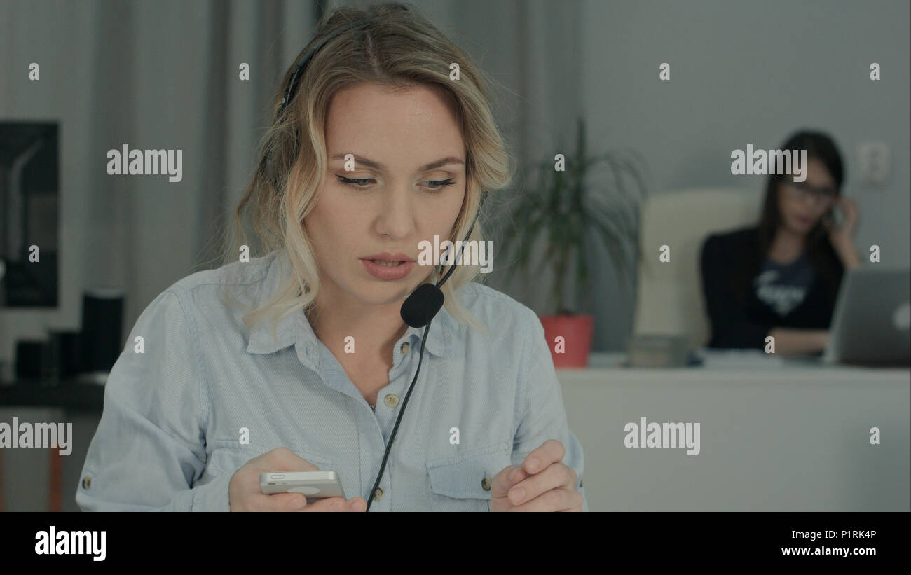 Call center specialist multitasking at work Stock Photo - Alamy