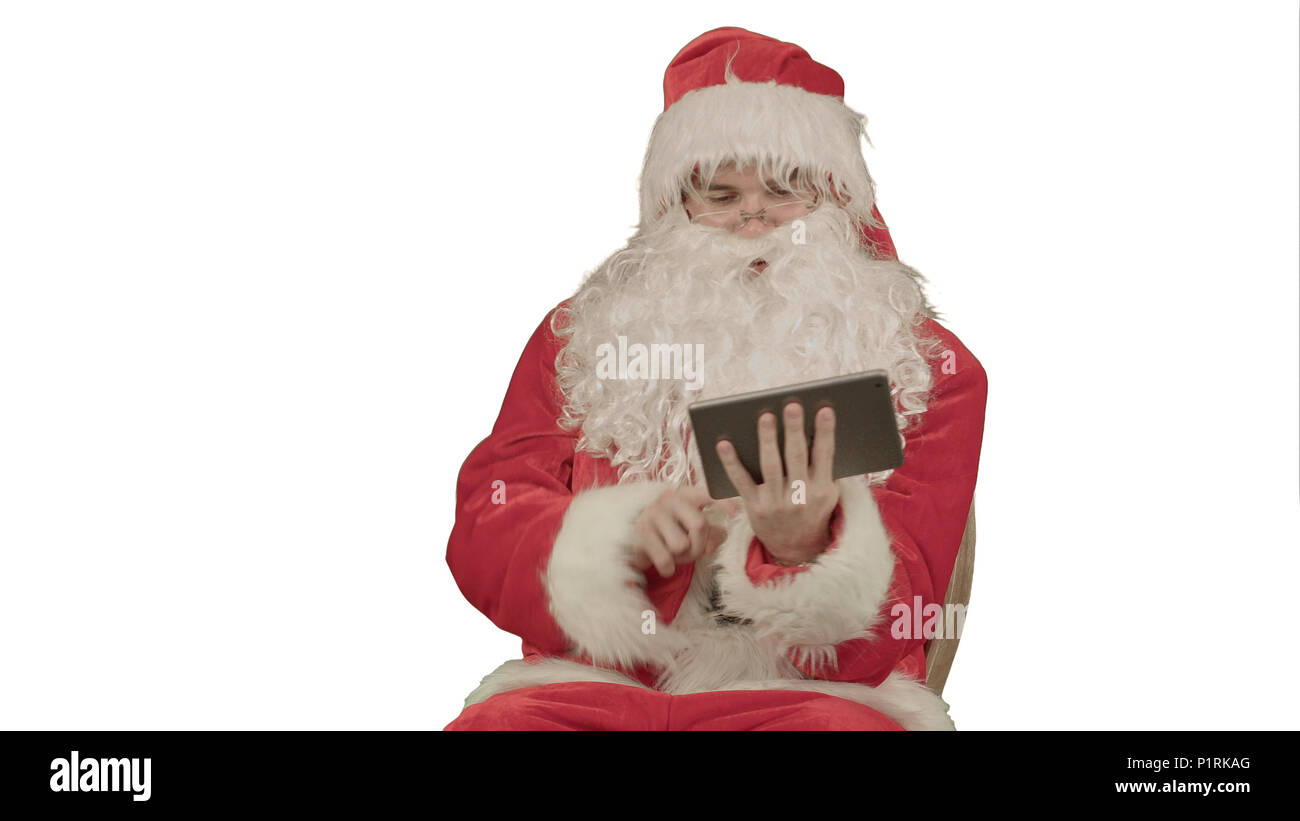 Santa listening music and touching tablet on white background Stock ...