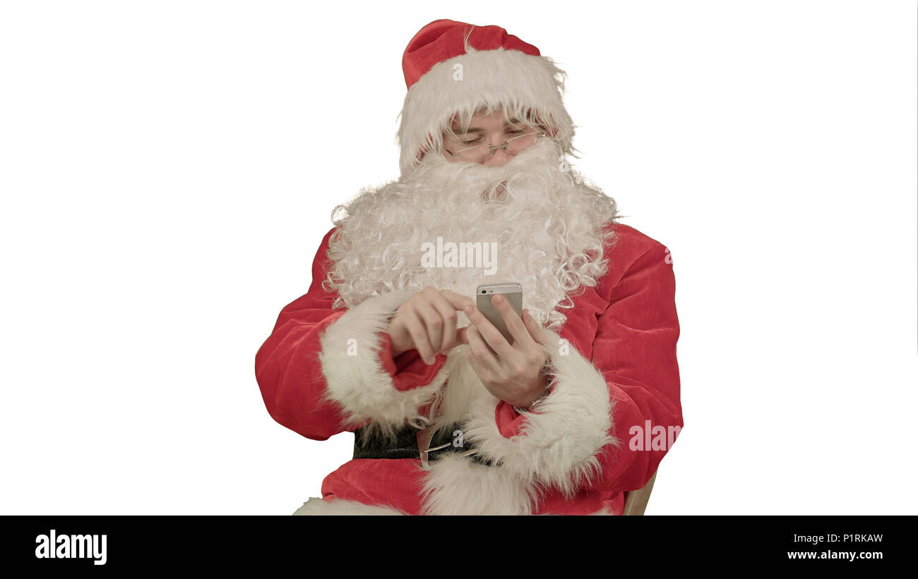 santa claus reads and sends text messages from his cell phone on white ...