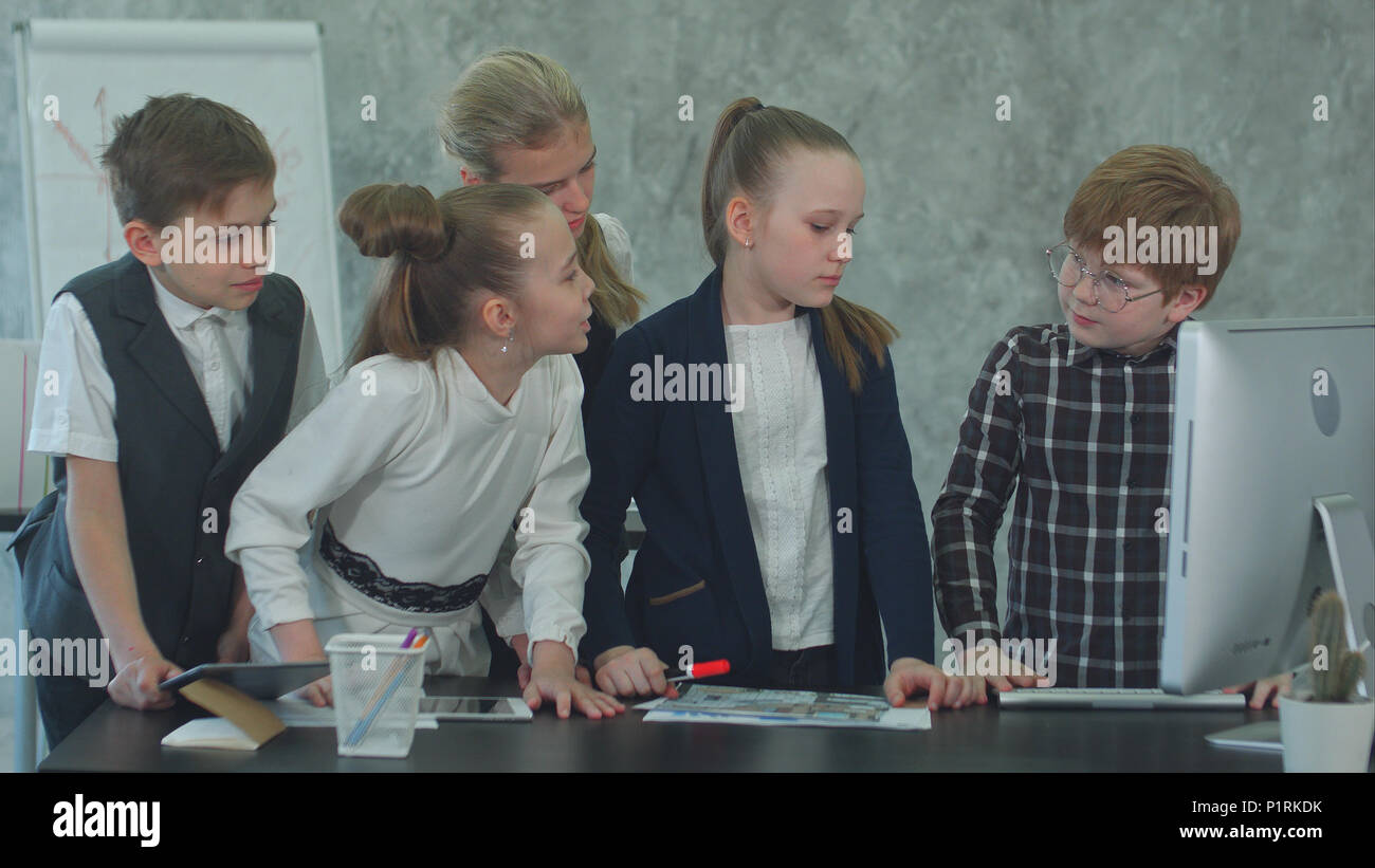 Kid business team working in the office together with computer Stock ...