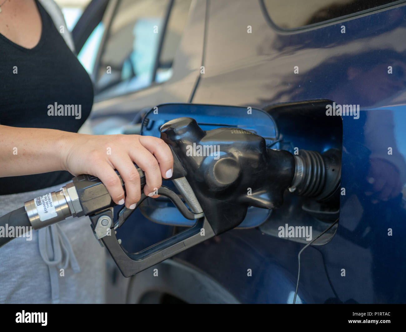Woman pumping gas hi-res stock photography and images - Alamy