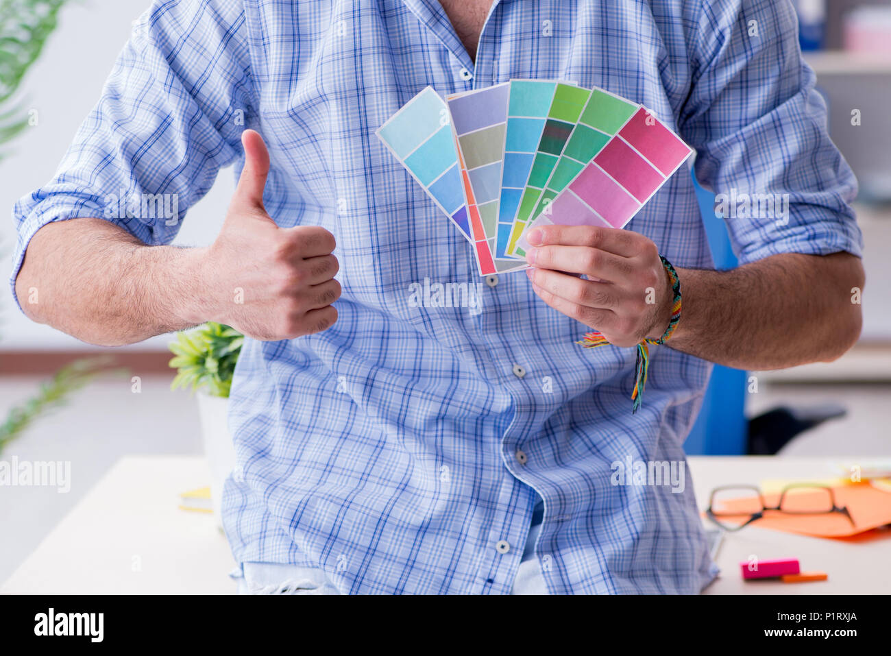 Young designer working in his studio on new project Stock Photo - Alamy
