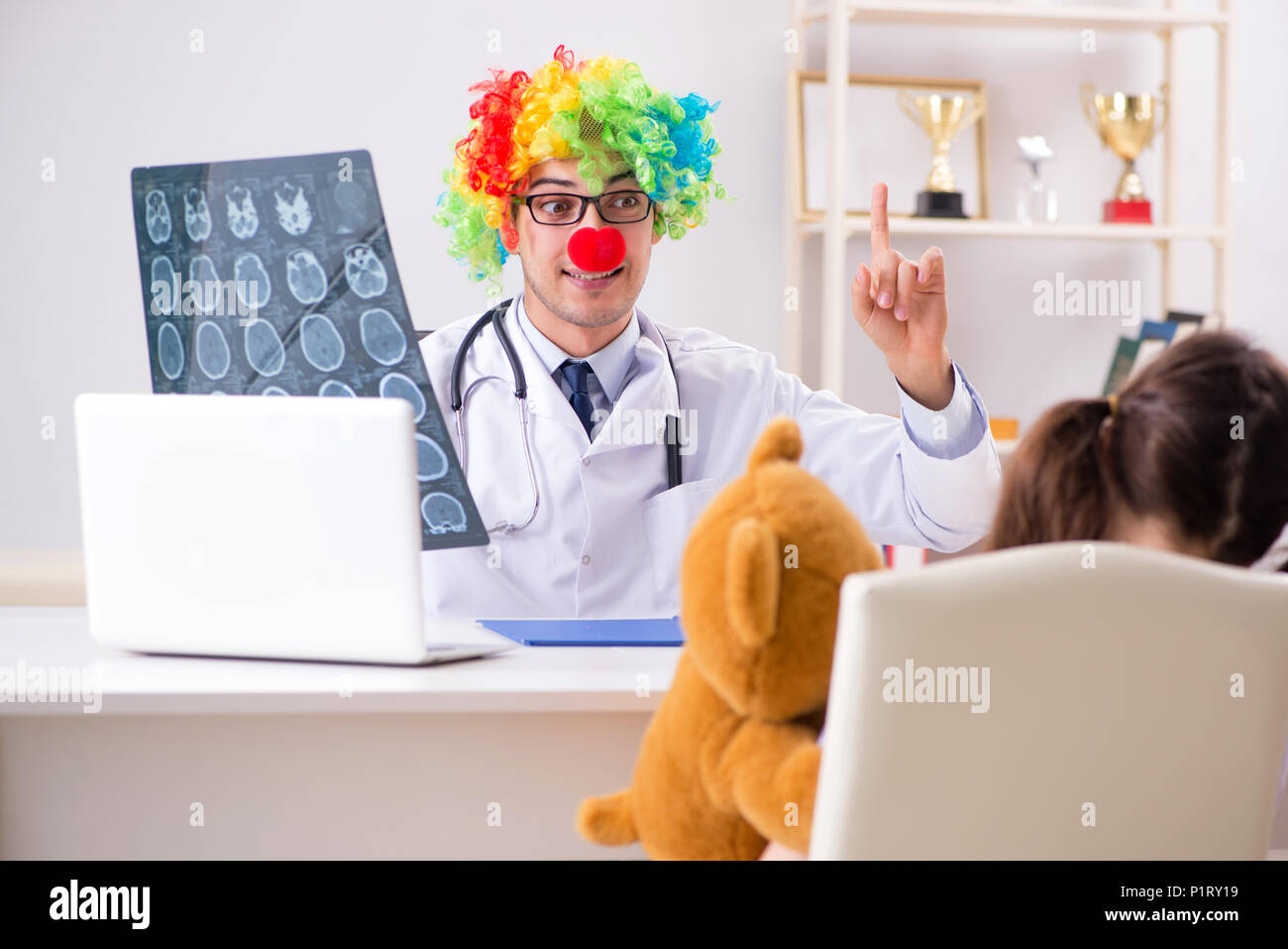 Funny pediatrician with little girl at regular check-up Stock Photo - Alamy