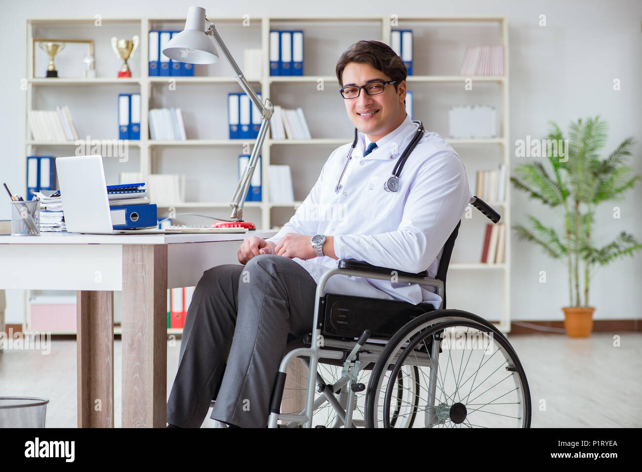 Disabled doctor on wheelchair working in hospital Stock Photo - Alamy