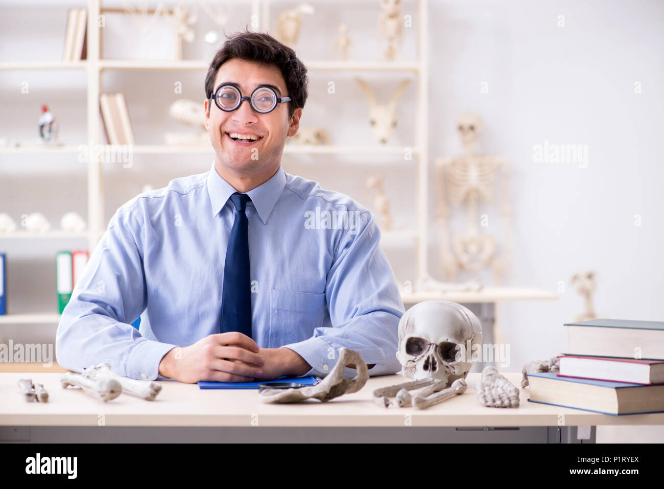 Funny crazy professor studying human skeleton Stock Photo - Alamy
