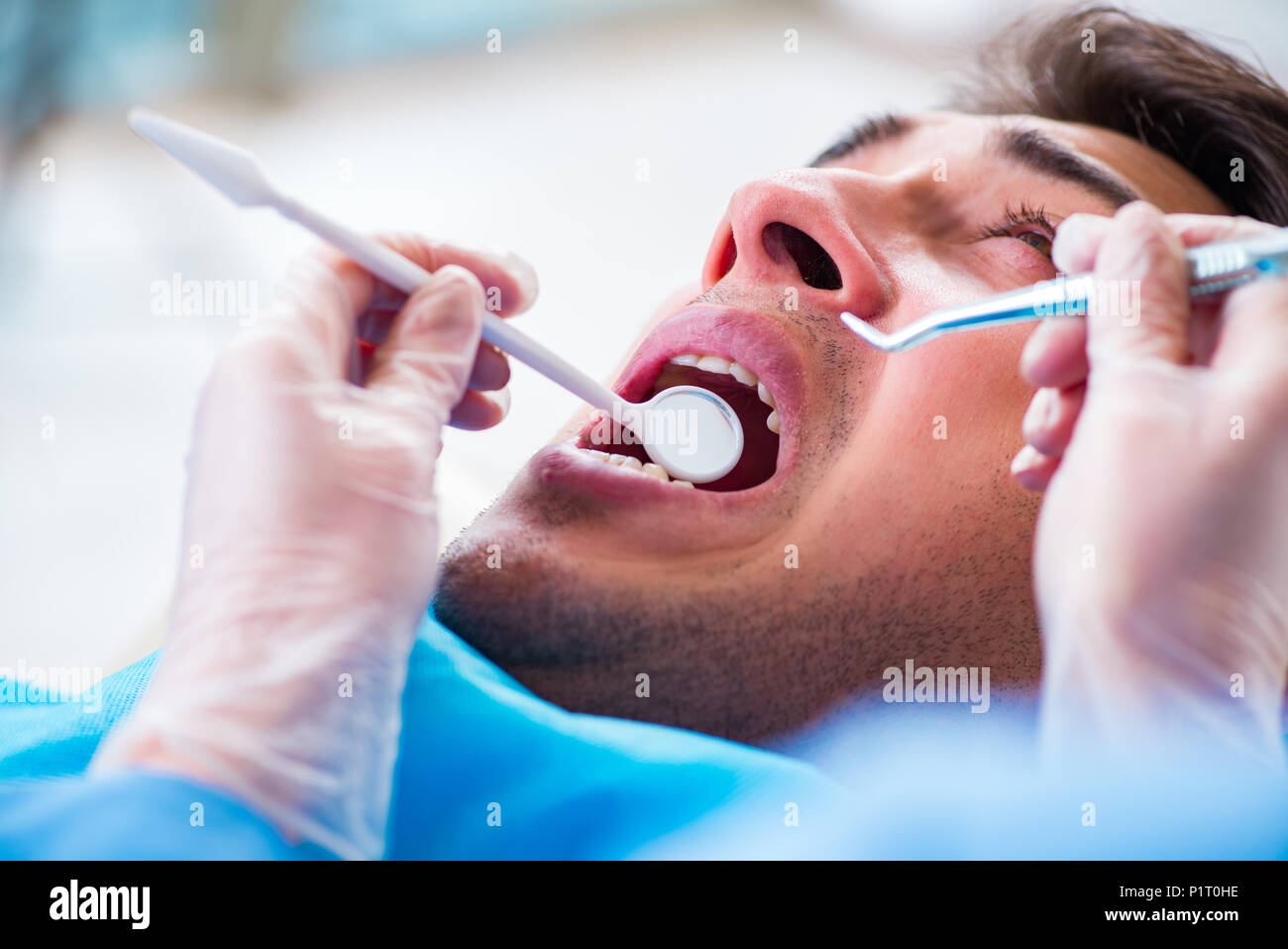 Man patient visiting dentist for regular check-up Stock Photo - Alamy