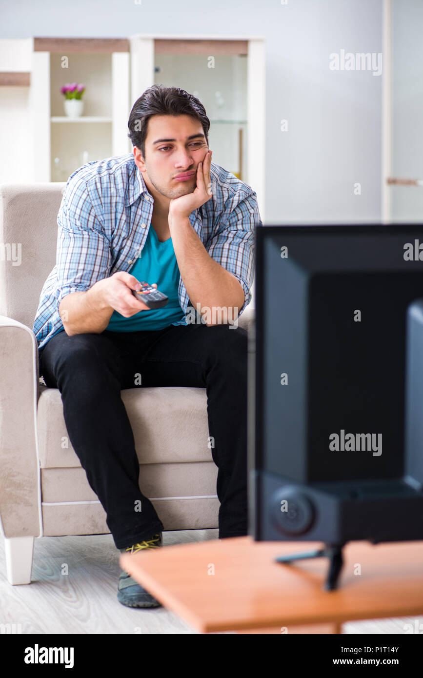 Man watching tv at home Stock Photo - Alamy