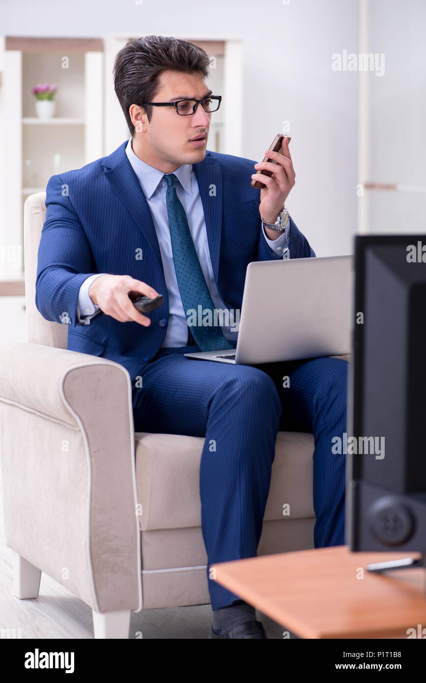 Businessman watching tv in the office Stock Photo - Alamy