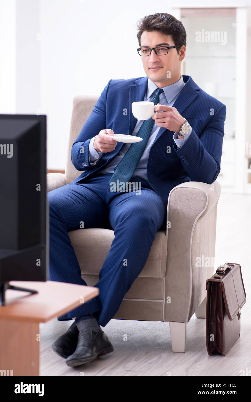 Businessman watching tv in the office Stock Photo - Alamy