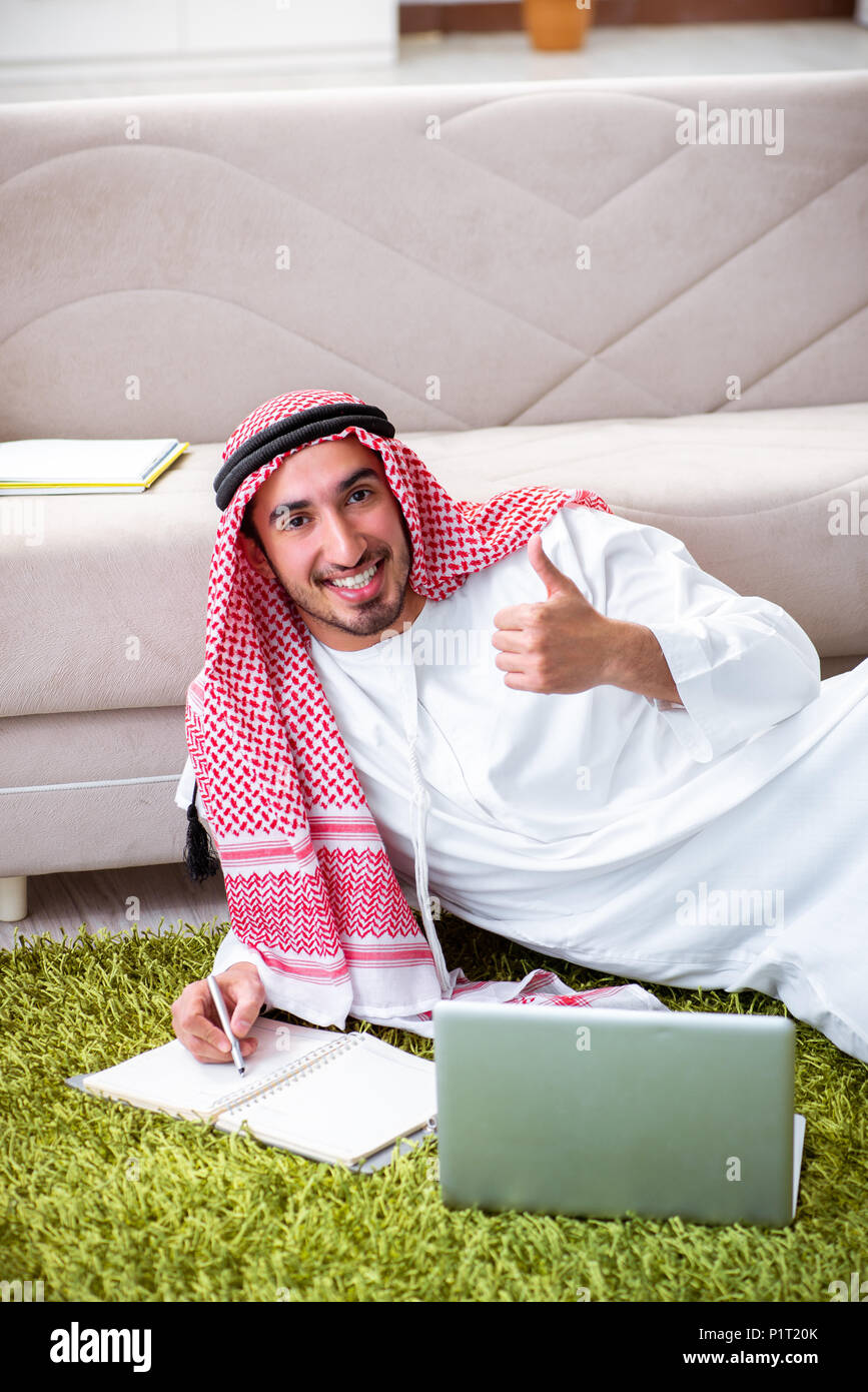 Arab man working at home on his work Stock Photo - Alamy