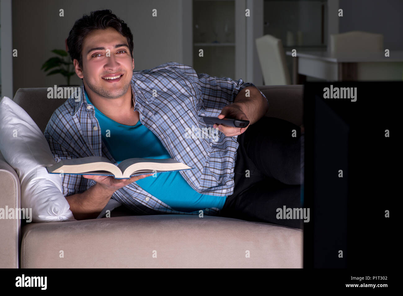 Man switching tv channels night hi-res stock photography and images - Alamy