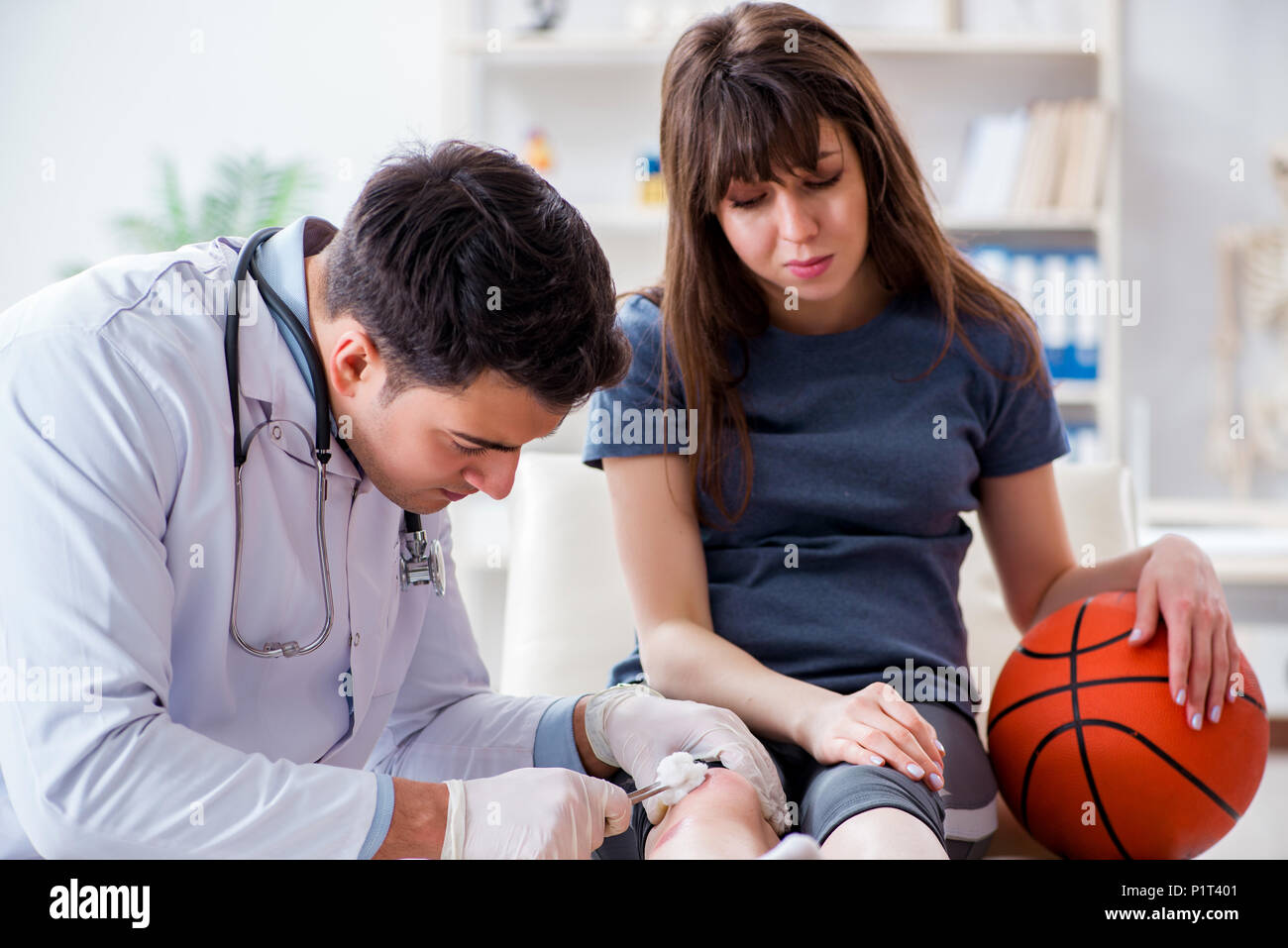 Female basketball player visiting doctor after injury Stock Photo - Alamy